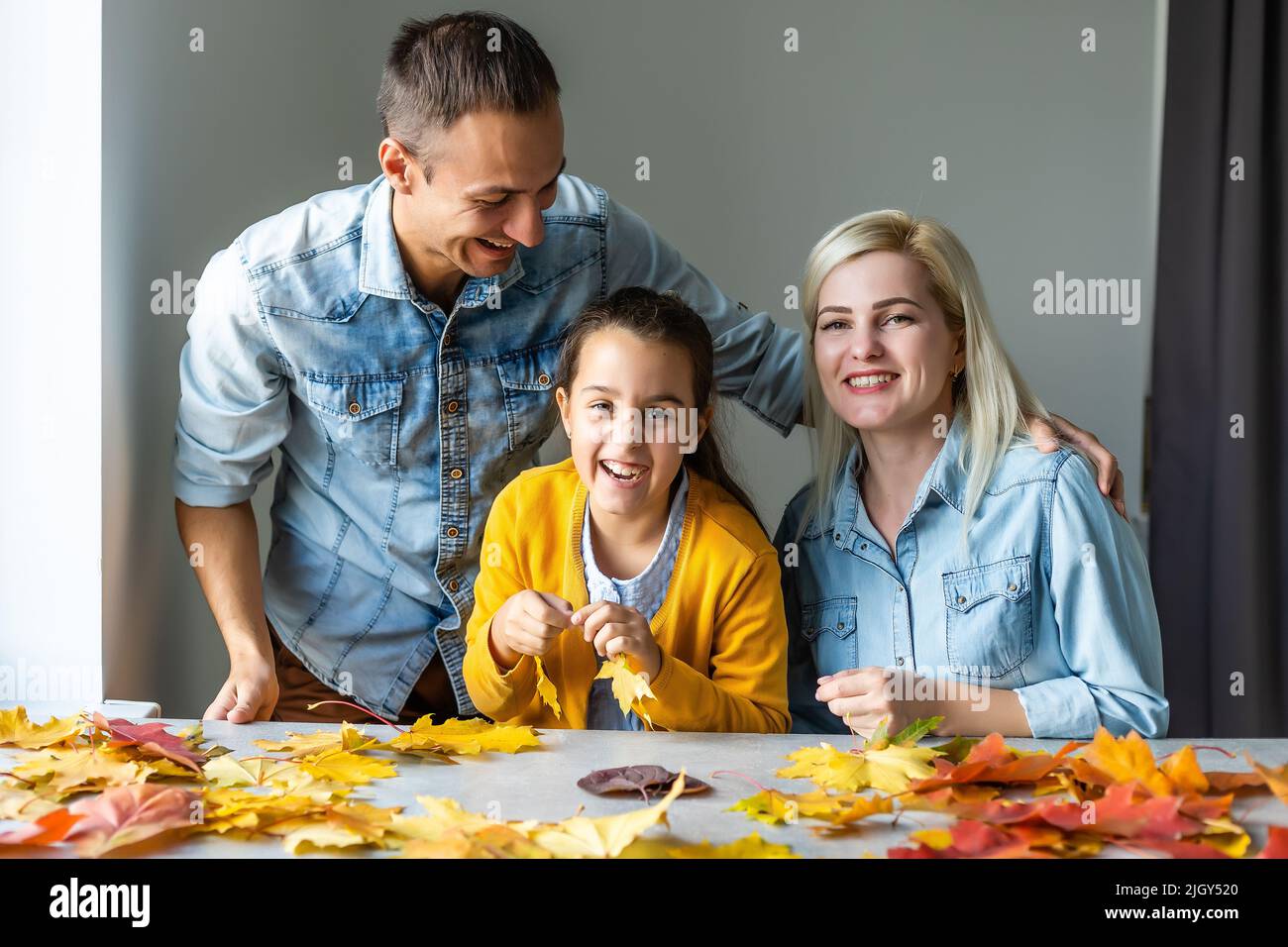 Portrait of family during the autumn Stock Photo - Alamy