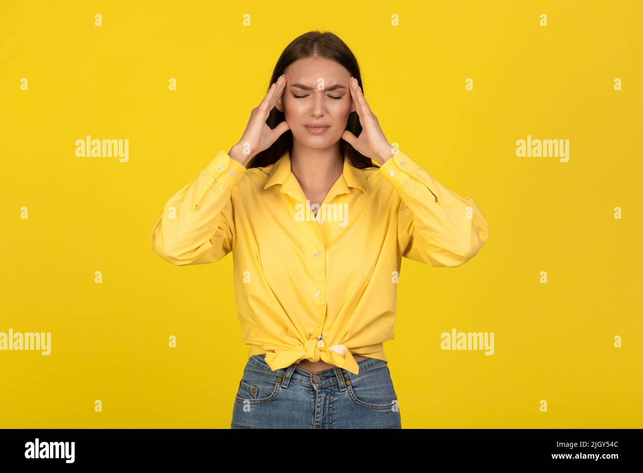 Sick Woman Suffering From Headache Standing On Yellow Background Stock ...