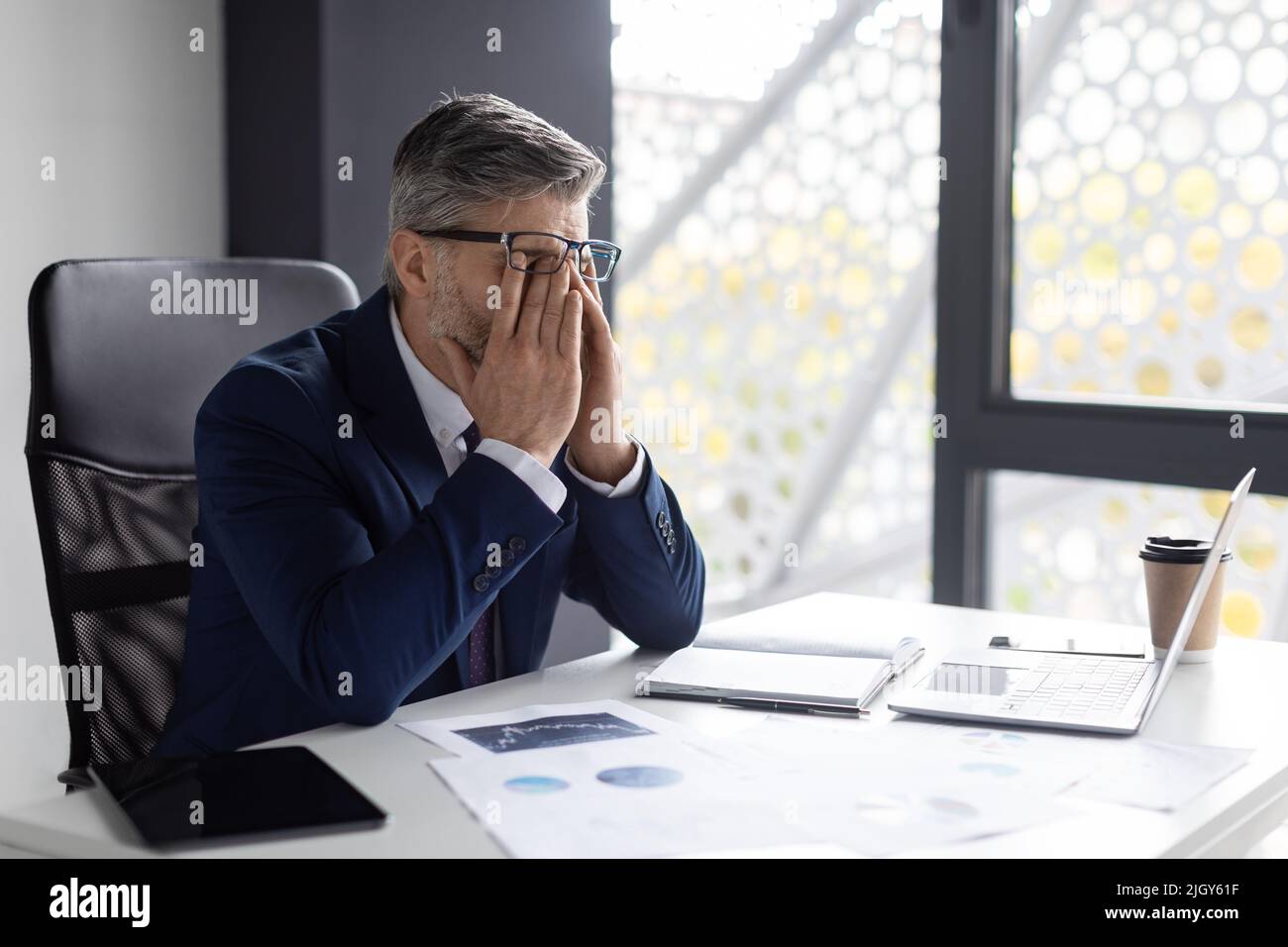 Job Burnout. Exhausted Mature Businessman Sitting At Workplace And ...