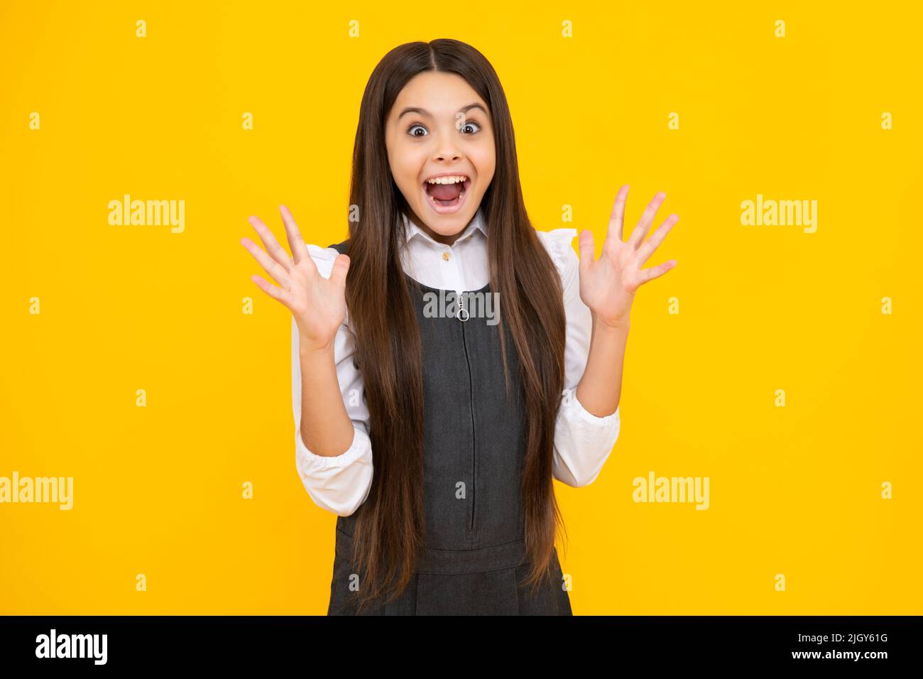Child with positive expression, joyful and exciting over yellow ...