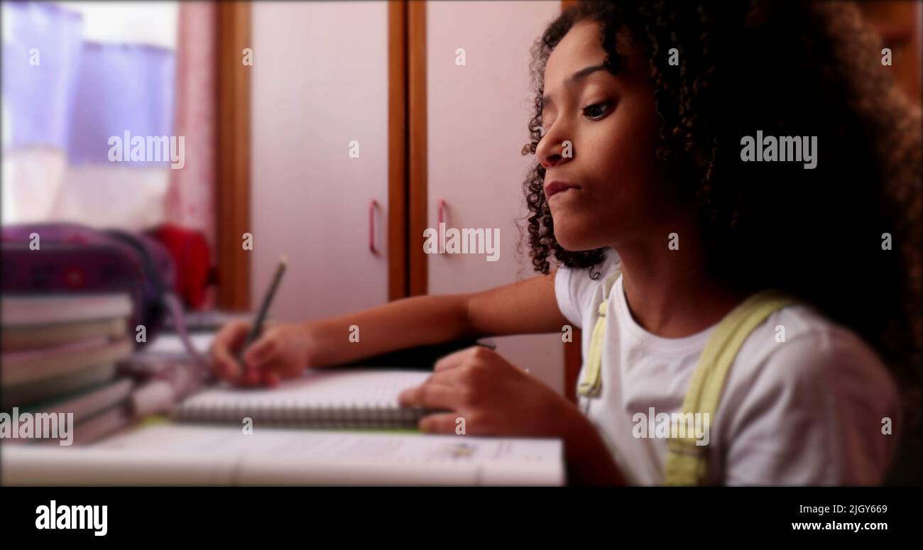 Cute little school gir writing notes doing homework Stock Photo - Alamy