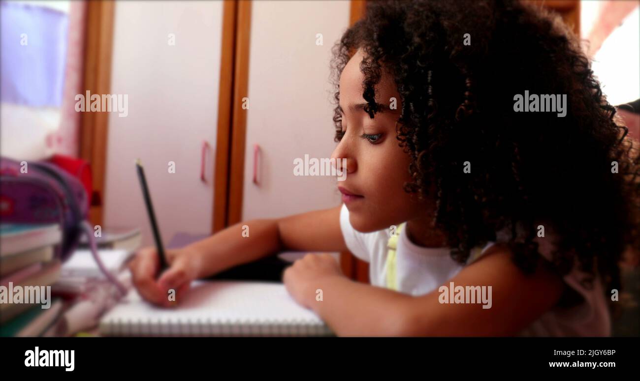 Ethnically diverse little girl child writing notes with pen. kid ...