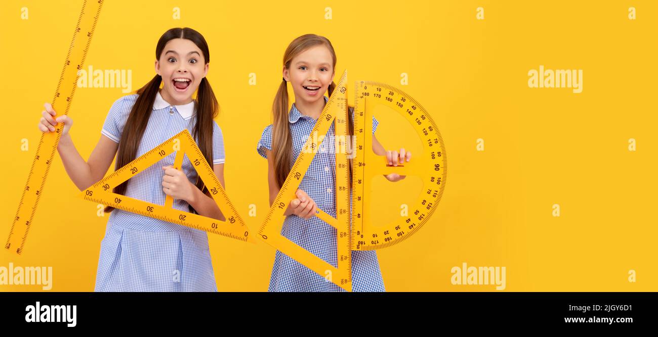 School girls friends. Happy teen girls hold geometric tools. School ...