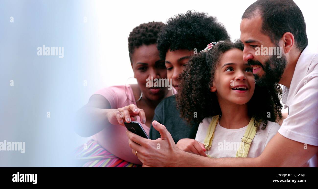 Family looking cellphone together parents hi-res stock photography and ...