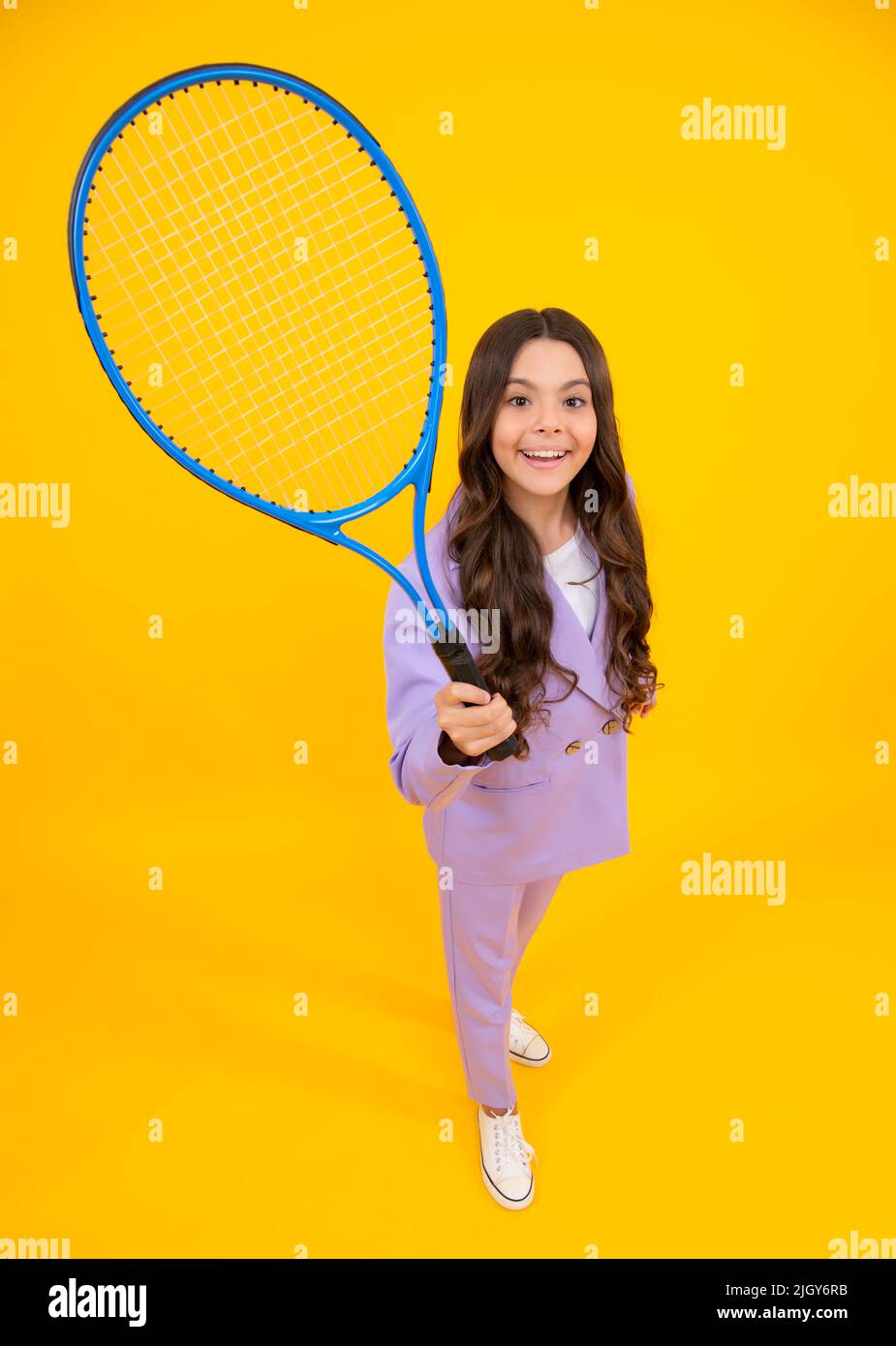 Fashion teenage tennis player girl in trendy suit hold tennis racket ...