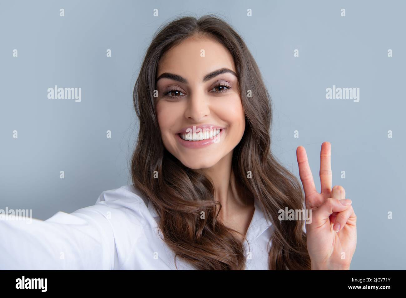 Portrait of cheerful smiling woman having video-call, shooting selfie ...