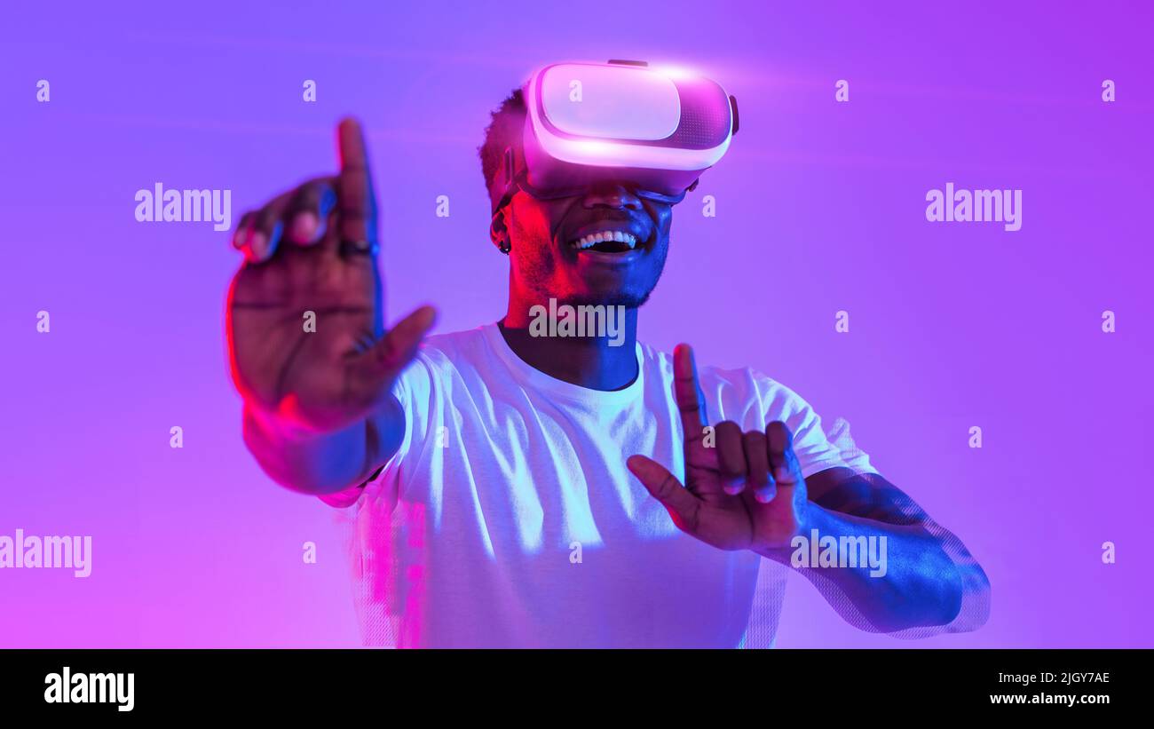 Cool guy in VR glasses exploring cyberspace, touching imaginary screen ...