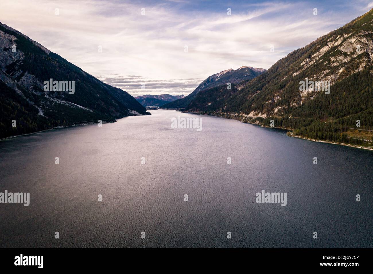An aerial view of the Achen Lake surrounded by mountain ranges in ...