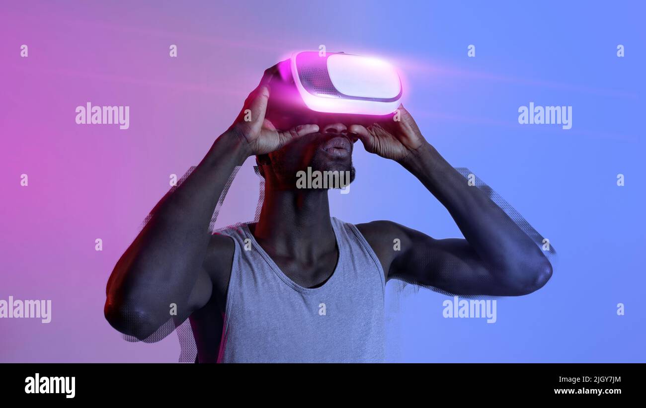 Athletic black guy wearing VR headset, doing virtual workout Stock ...