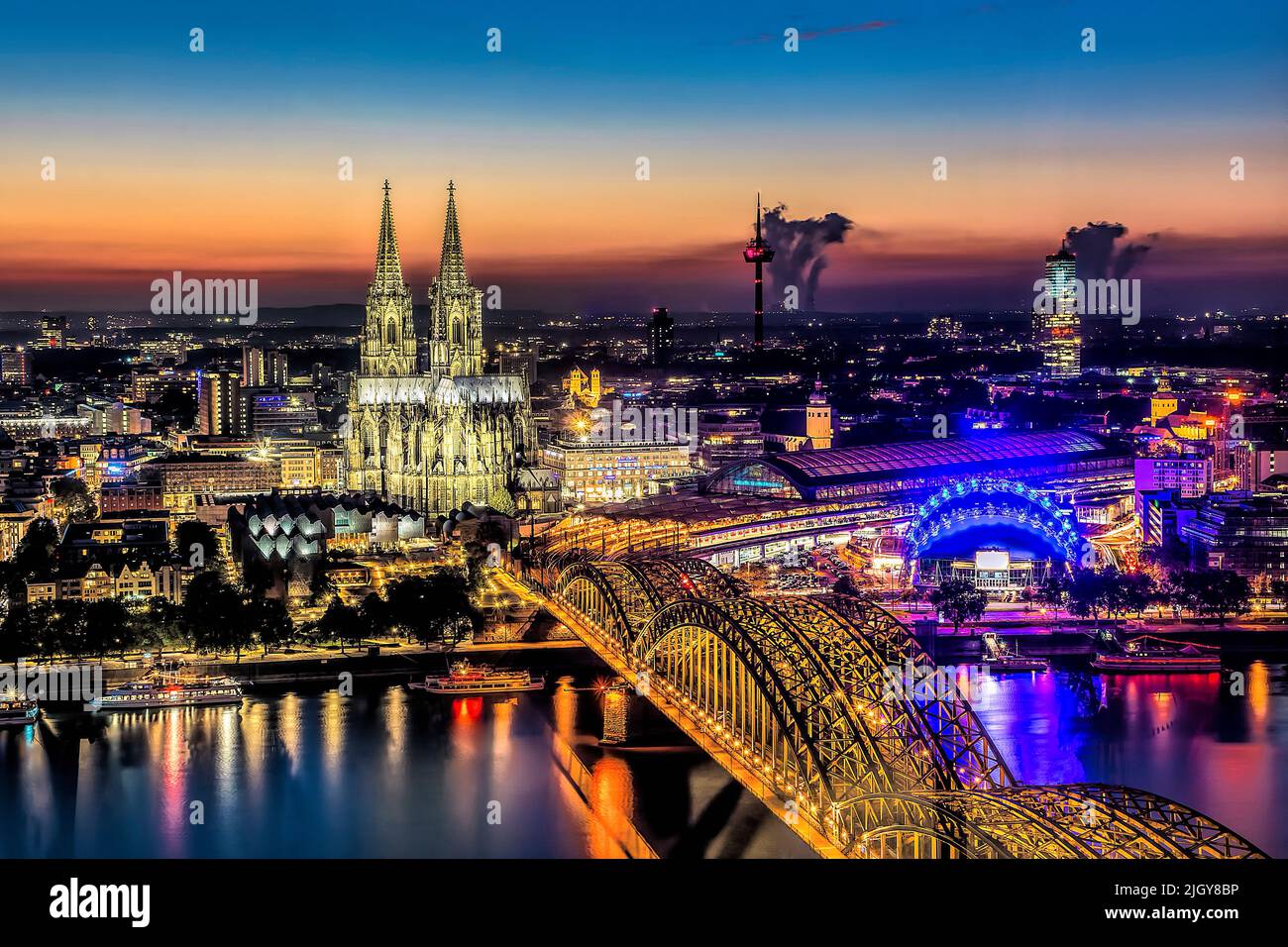 Illuminated Cologne Cathedral and Hohenzollern Bridge at night Stock ...