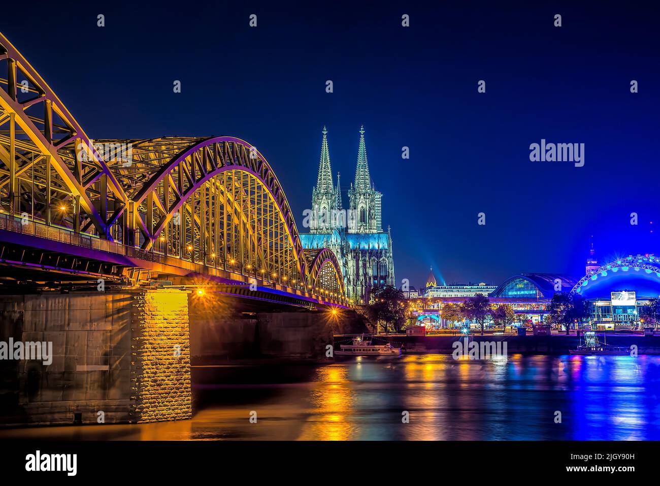 Illuminated Cologne Cathedral and Hohenzollern Bridge at night Stock ...
