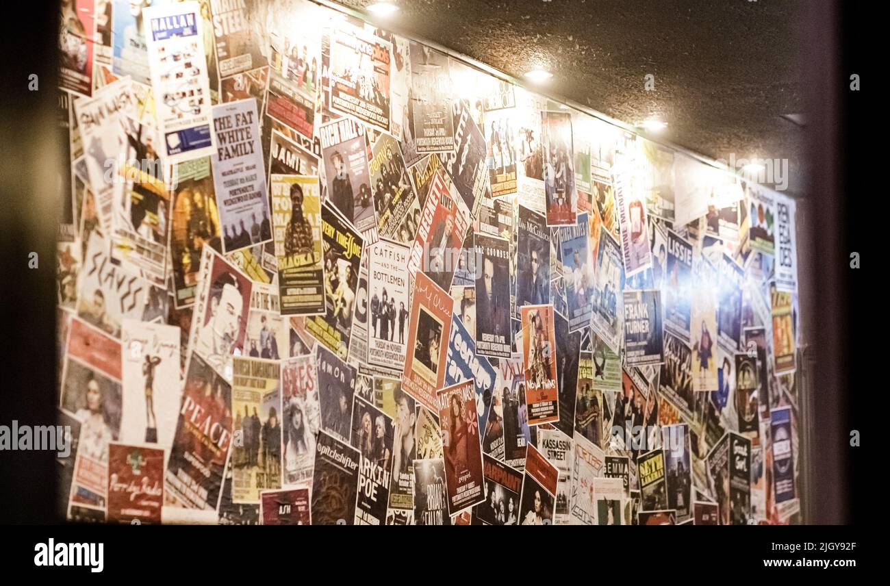 Lots of concert posters on the wall of music venue The Wedgewood Rooms ...