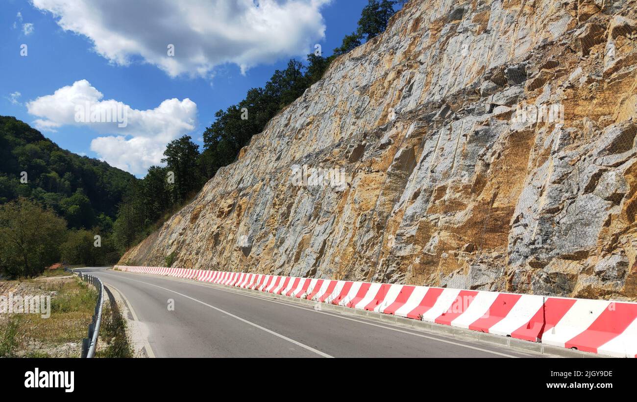 A countryside road with red and white strip sign Stock Photo - Alamy