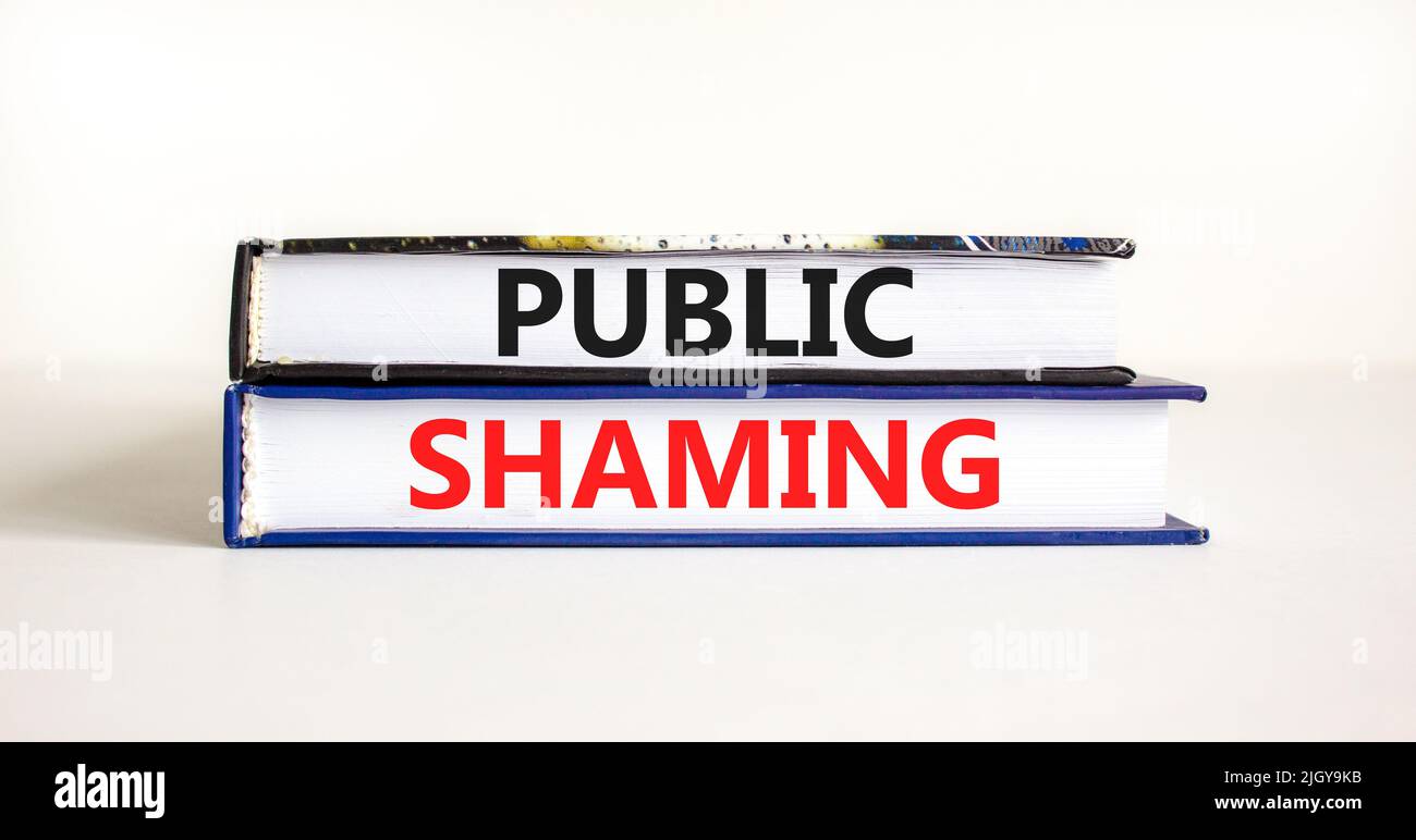 Public shaming symbol. Concept words Public shaming on books on a ...