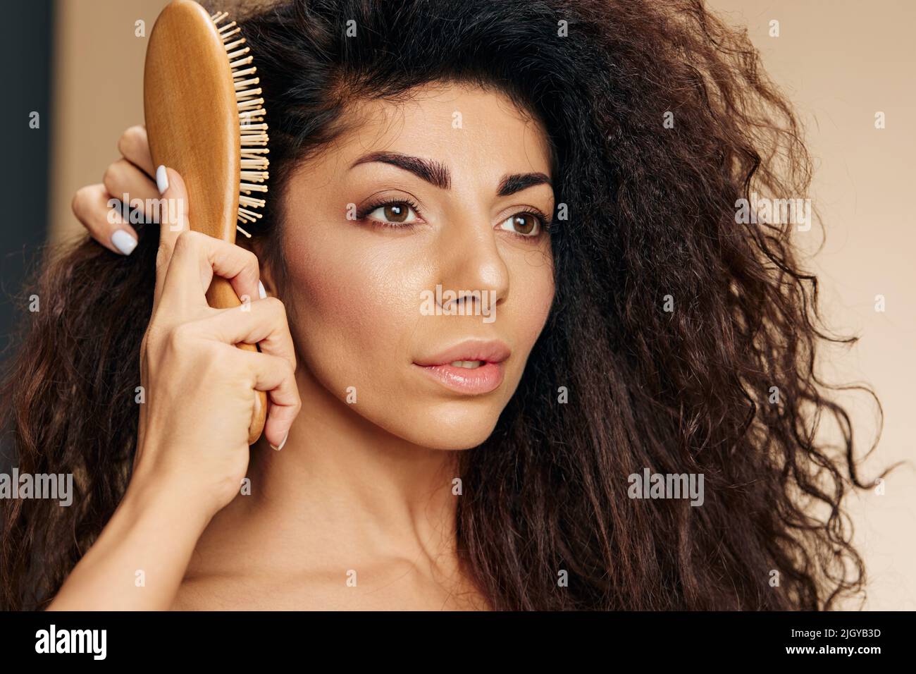 HEALTHY LONG HAIR TREATMENT CONCEPT. Pensive happy adorable tanned ...