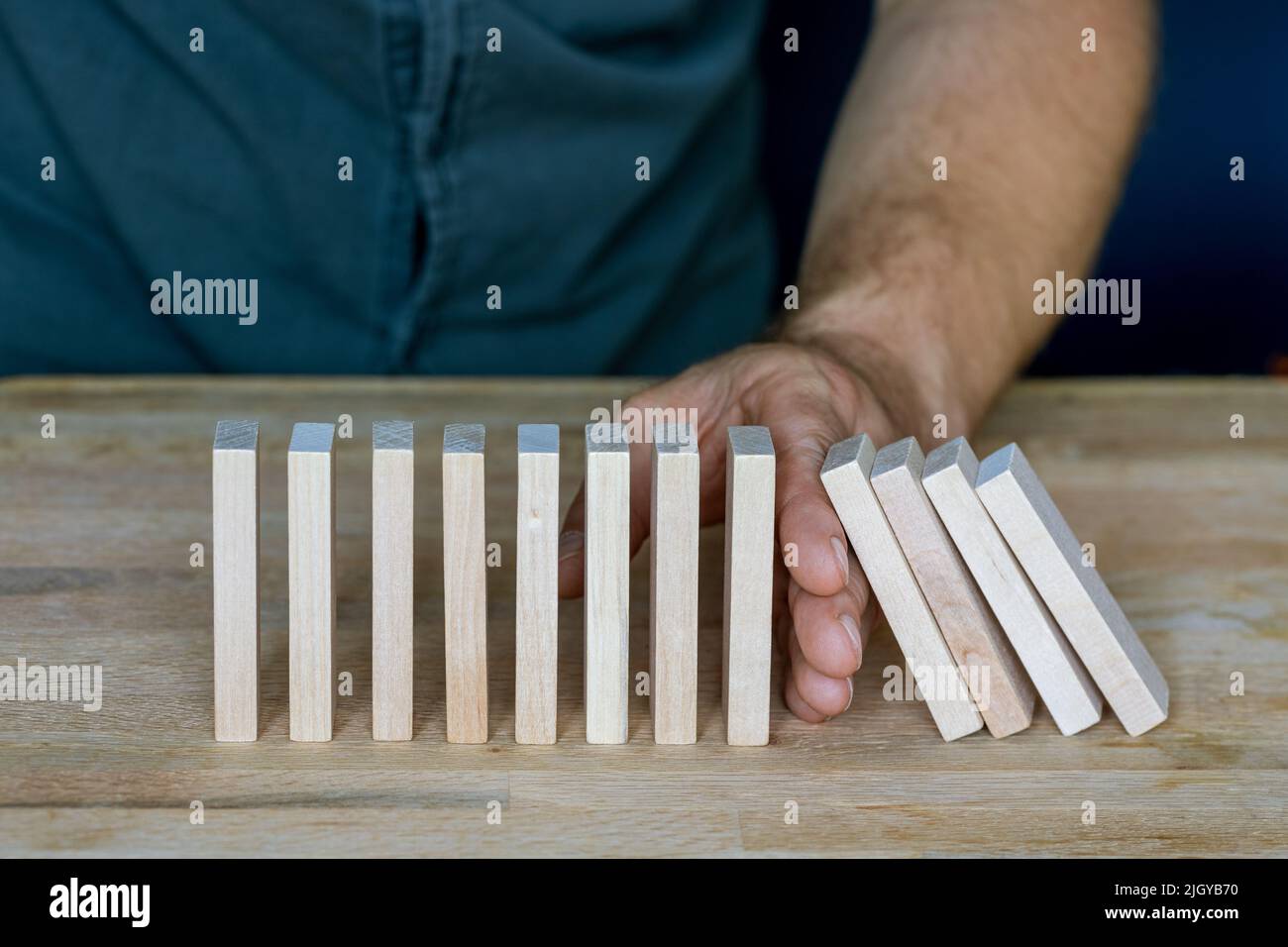 Businessman hand stop falling off wood block, planing and strategy ...
