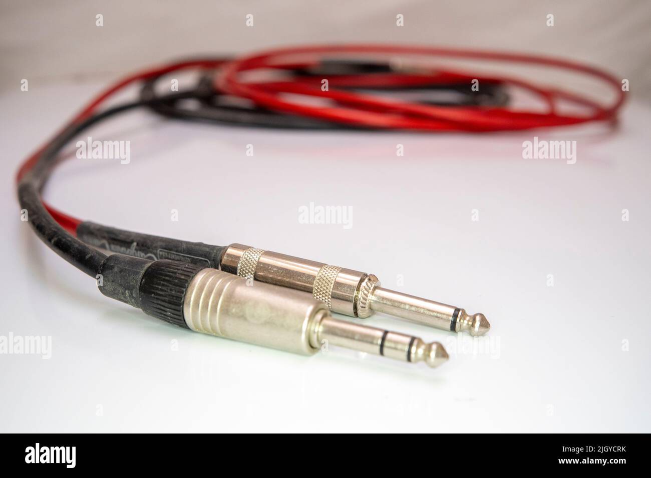 The one quarter inch stereo and mono audio cords on a white background ...