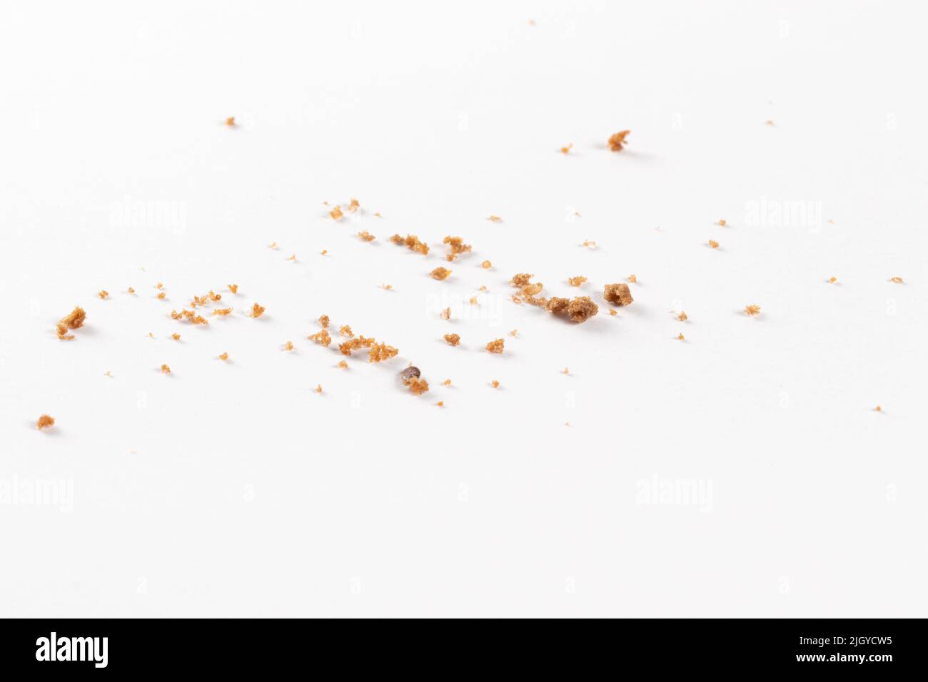 Scattered crumbs isolated on white background, bokeh Stock Photo - Alamy