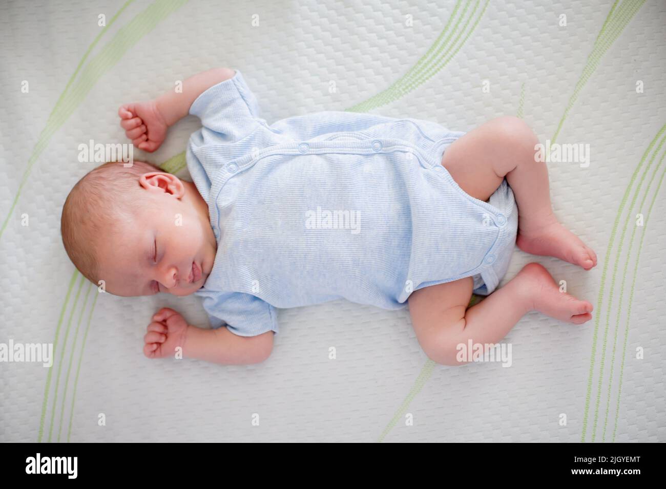 Cute little peaceful baby calm sleeps soundly in his crib in a bright ... Cute little peaceful baby calm sleeps soundly in his crib in a bright ...
