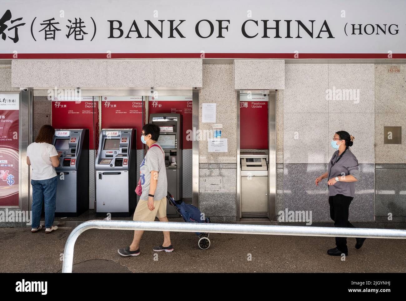 Pedestrian walk past the Chinese state-owned commercial banking company ...