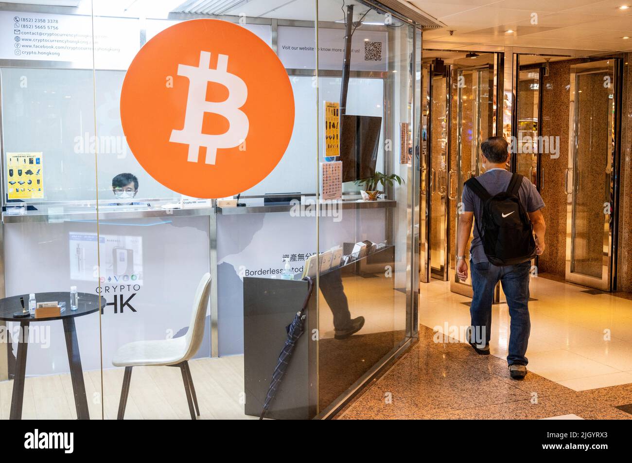 A store displays cryptocurrency electronic cash Bitcoin (BTC, BCH) logo ...