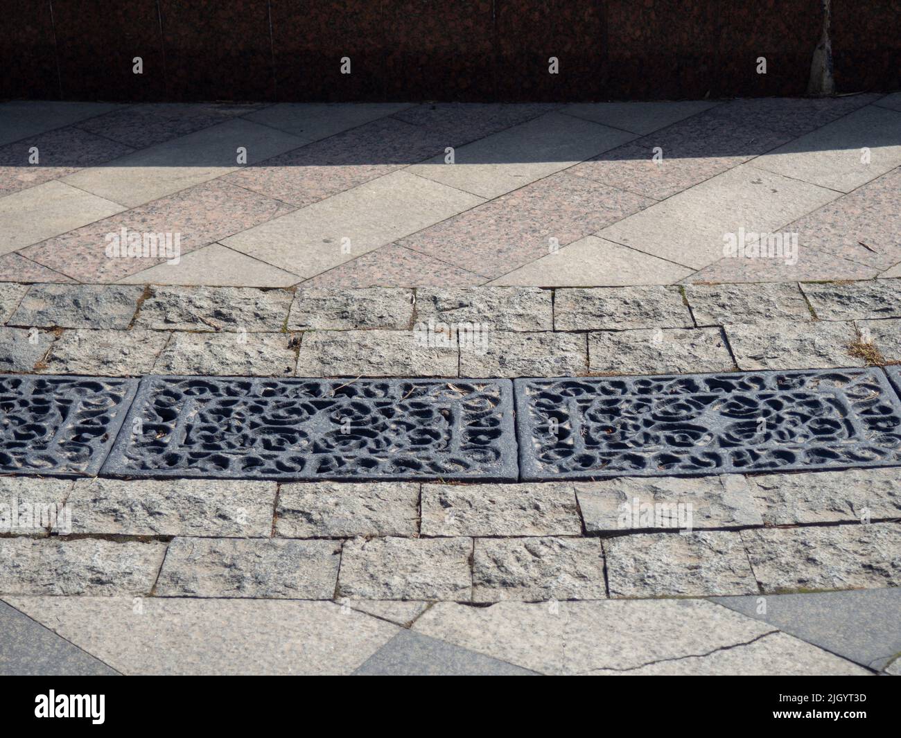 Storm drain in stone tiles. Urban environment. stone pavement Stock ...