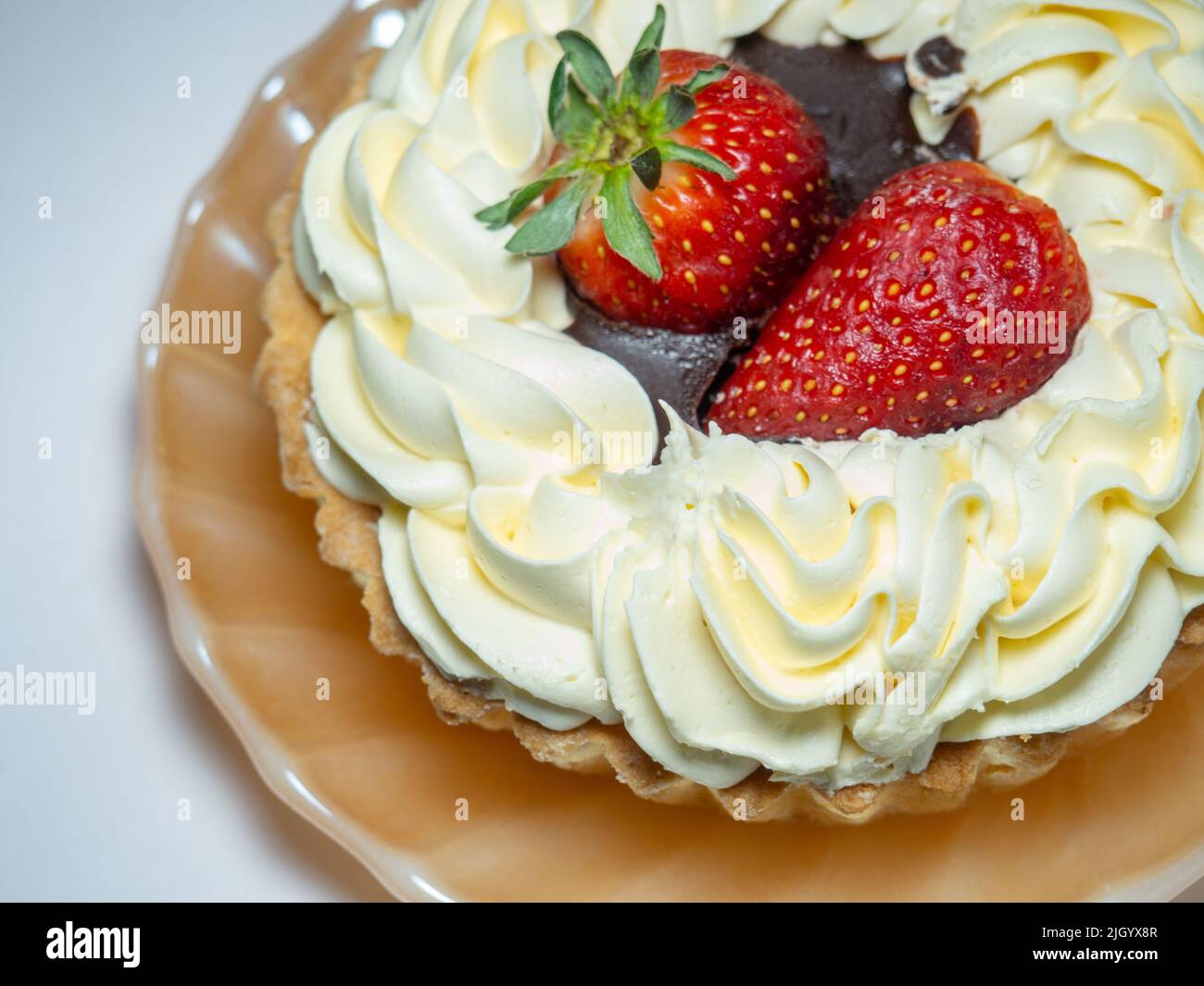 Cake with butter cream and strawberrie on the plates. Sweetness on a ...