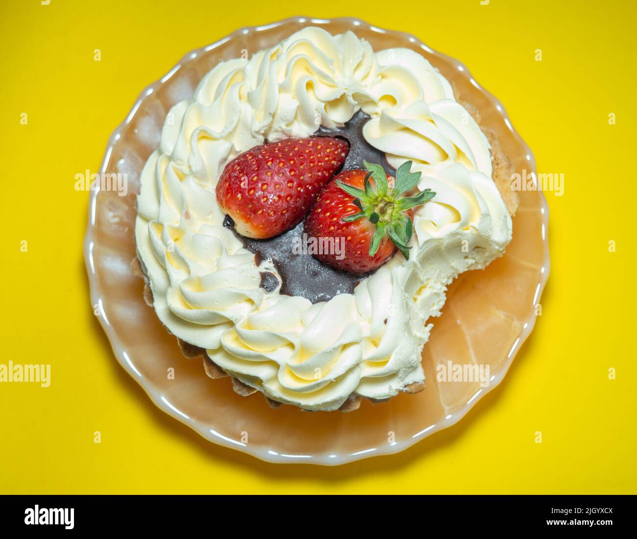 Cake with butter cream and strawberries. Cake on a yellow background ...