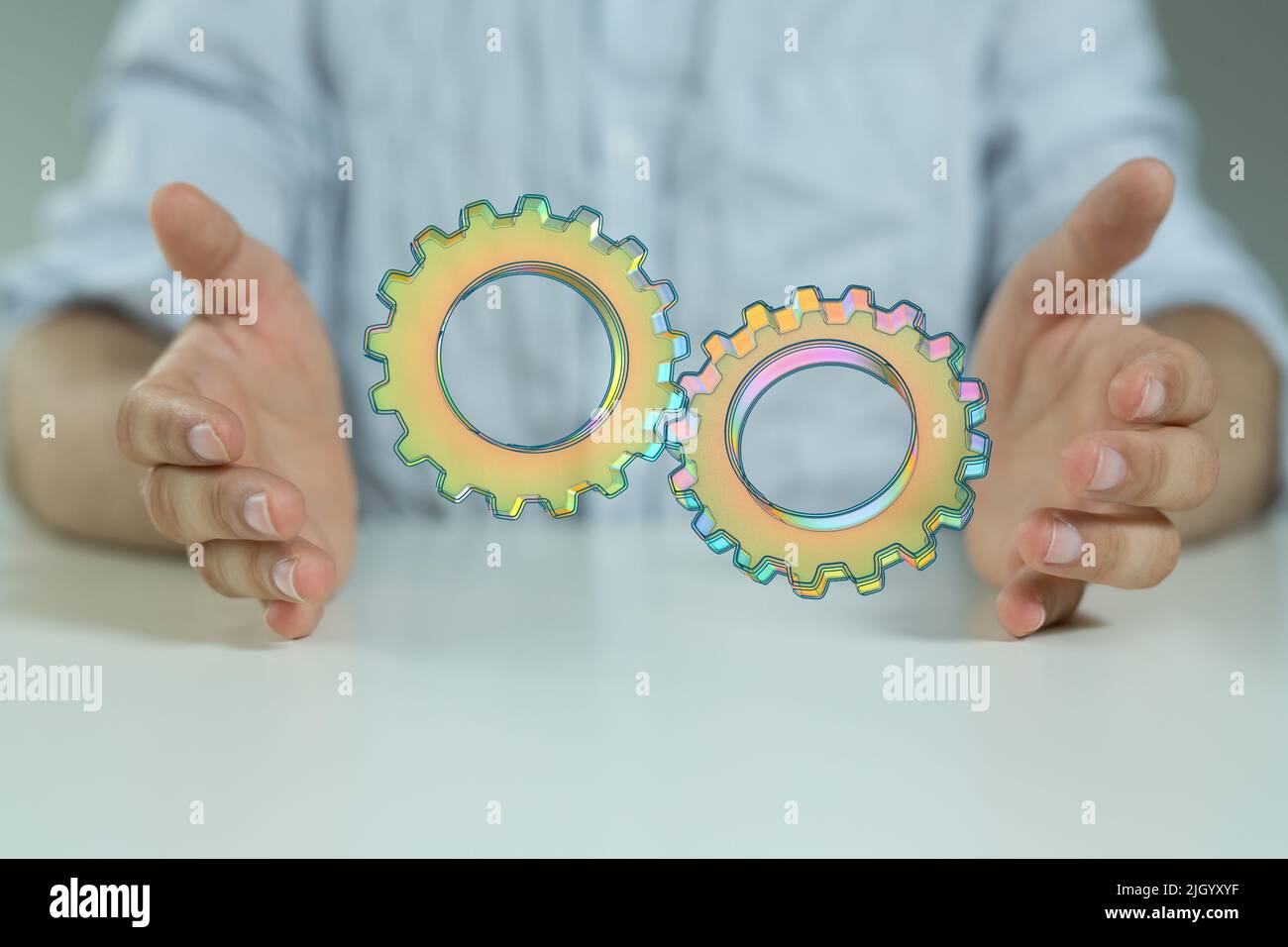 A person presenting a virtual projection of gears Stock Photo - Alamy