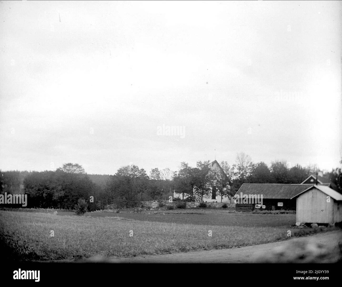 Landscape view with Lagga church, Lagga parish, Uppland 1917. Landscape ...