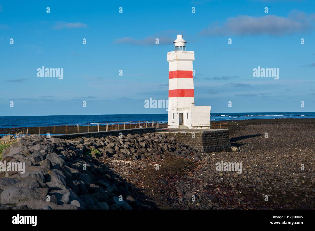 There are two lighthouses standing side by side at the tip of the ...