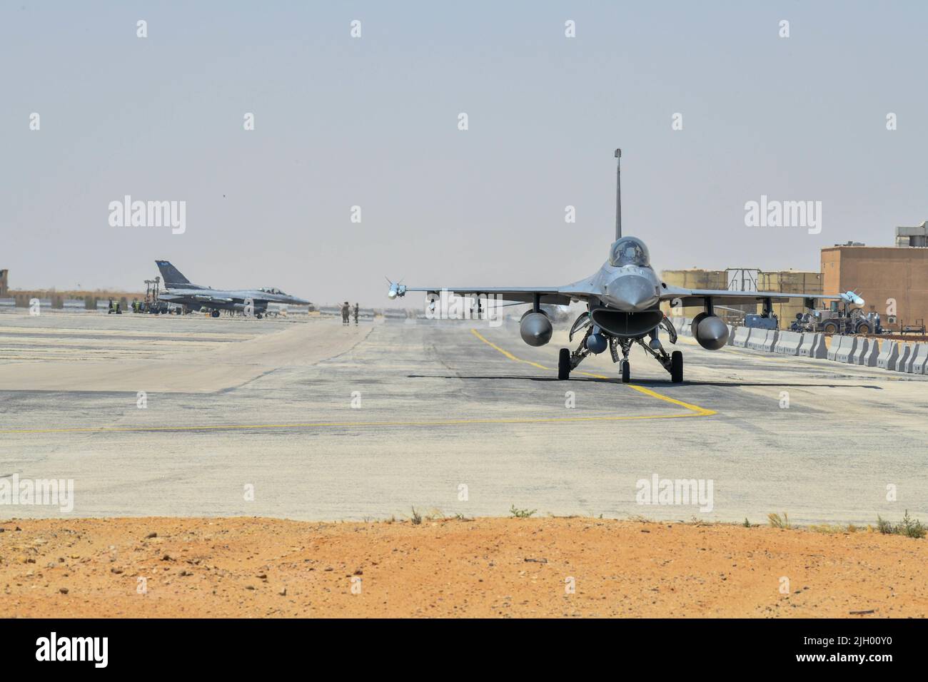 Two F-16 Fighting Falcons assigned to the 179th Expeditionary Fighter ...