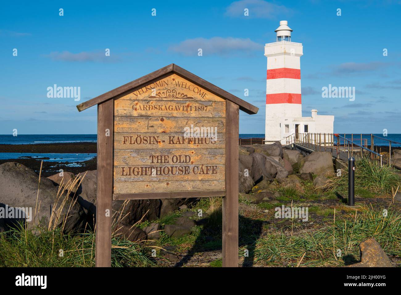 There are two lighthouses standing side by side at the tip of the ...