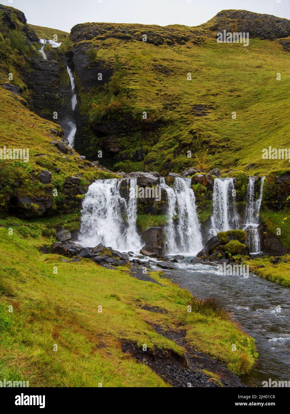 The river passes under a stone arch at the very top of the falls. As ...
