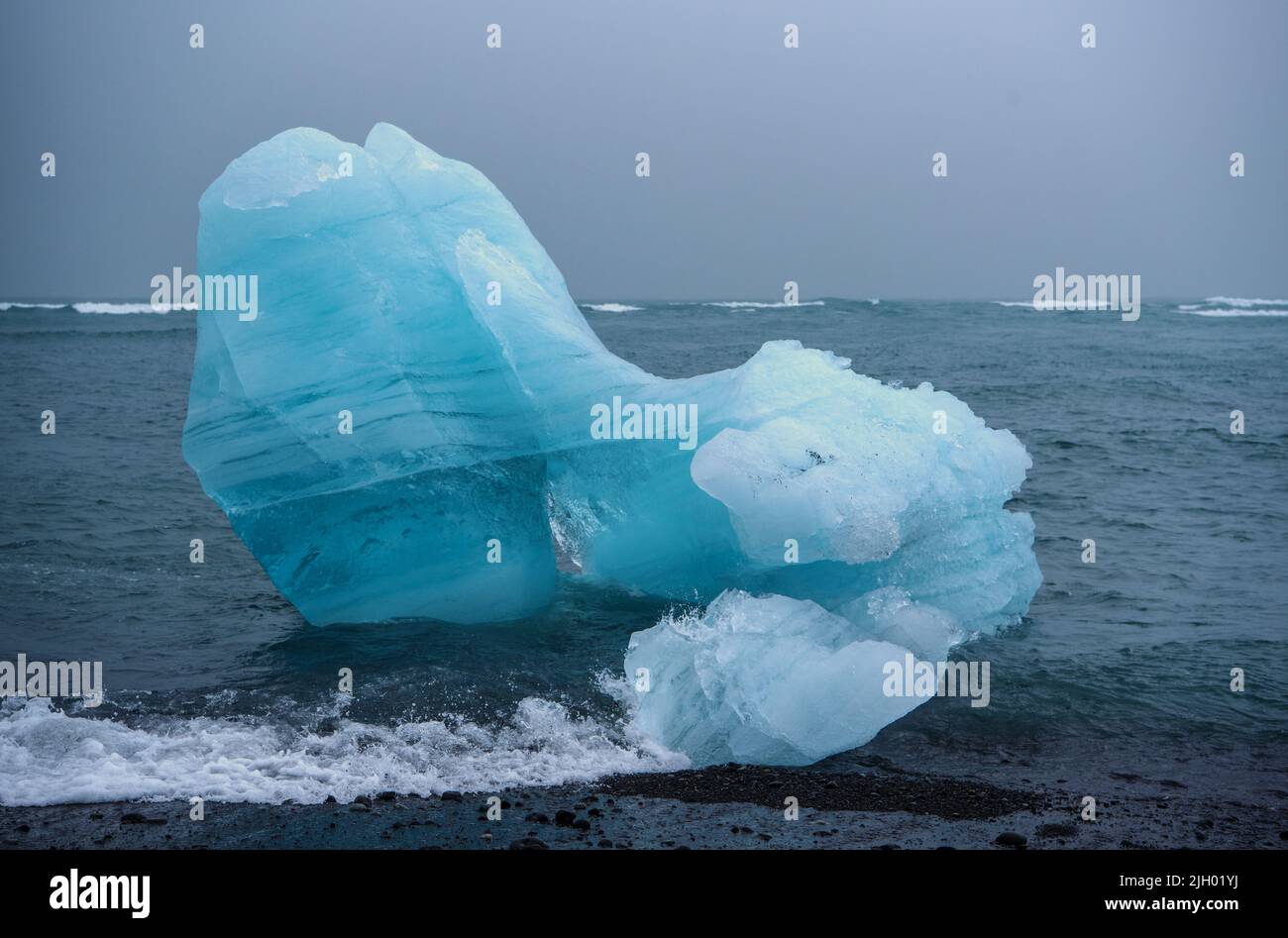 A small iceberg that just floated out of the Jökulsárlón glacial lagoon ...