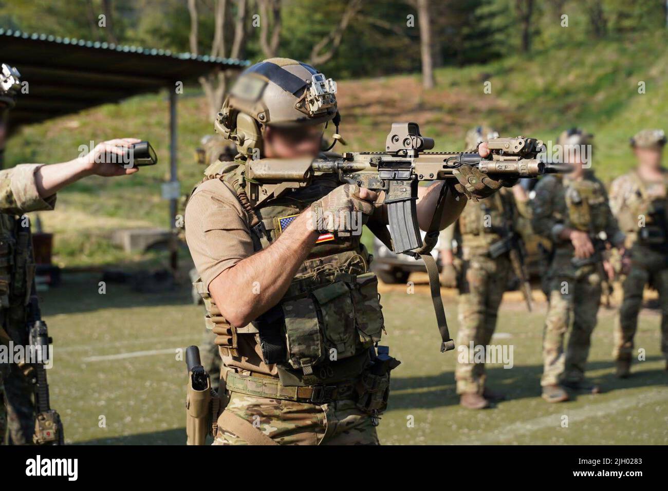 A Green Beret with 1st Special Forces Group (Airborne), fires at ...