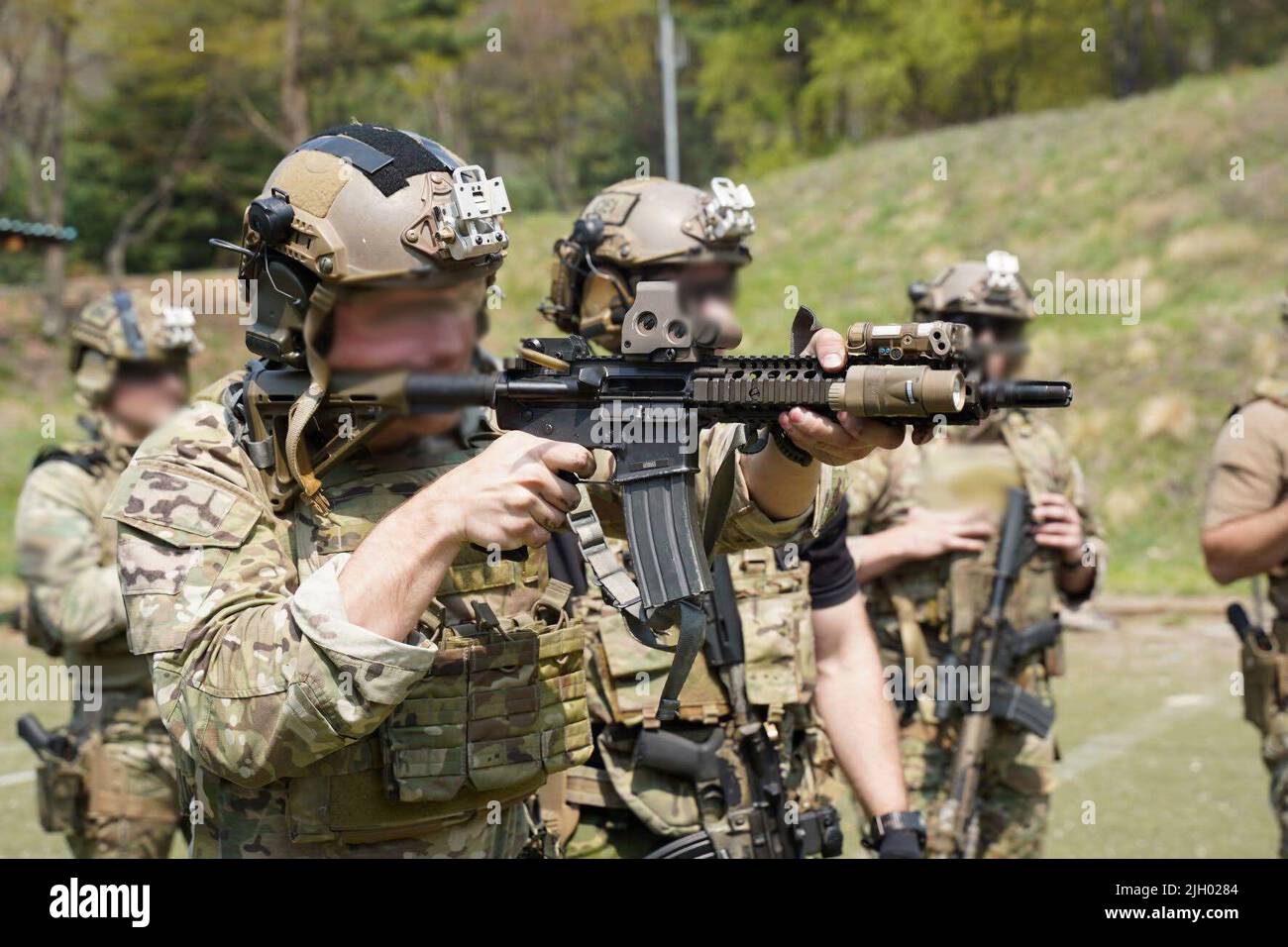 A Green Beret with 1st Special Forces Group (Airborne), fires at ...
