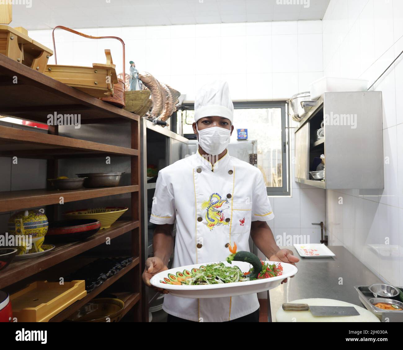 Accra, Ghana. 11th July, 2022. A Ghanaian apprentice shows Chinese cold ...