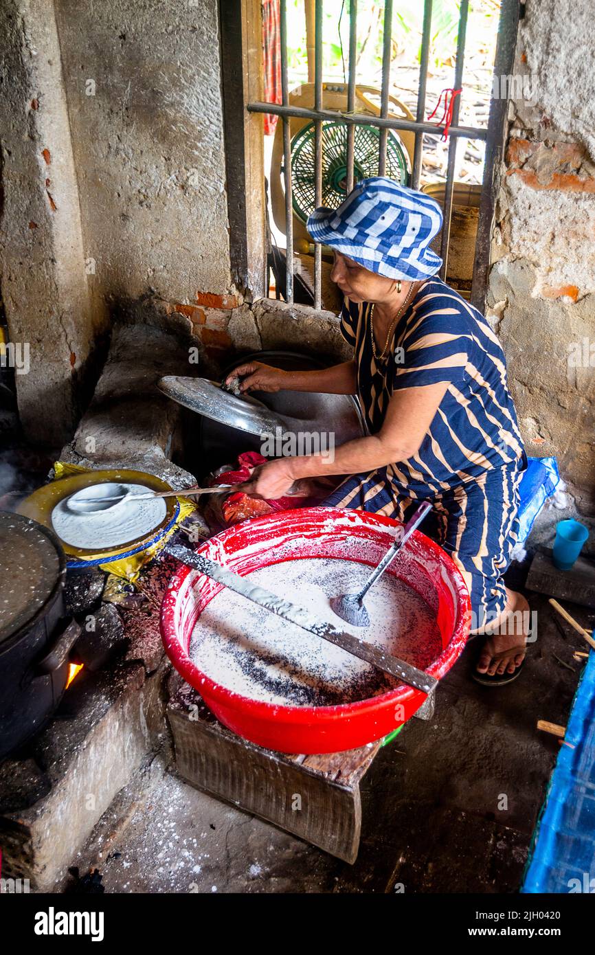 A Vietnamese woman is creating her Banh Trang rice cracker using ...