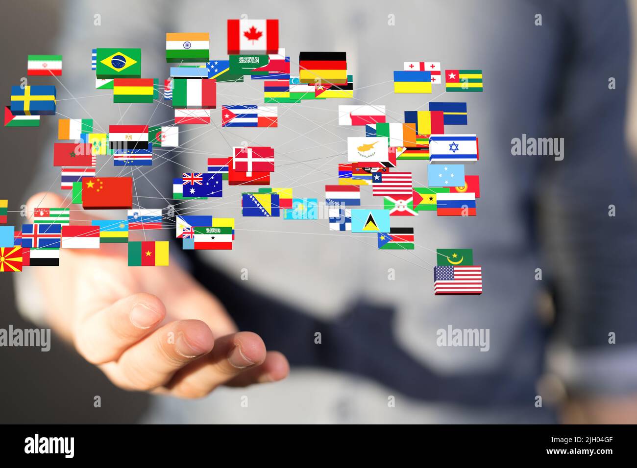 A person with his hand out toward 3D rendered country flags connected ...