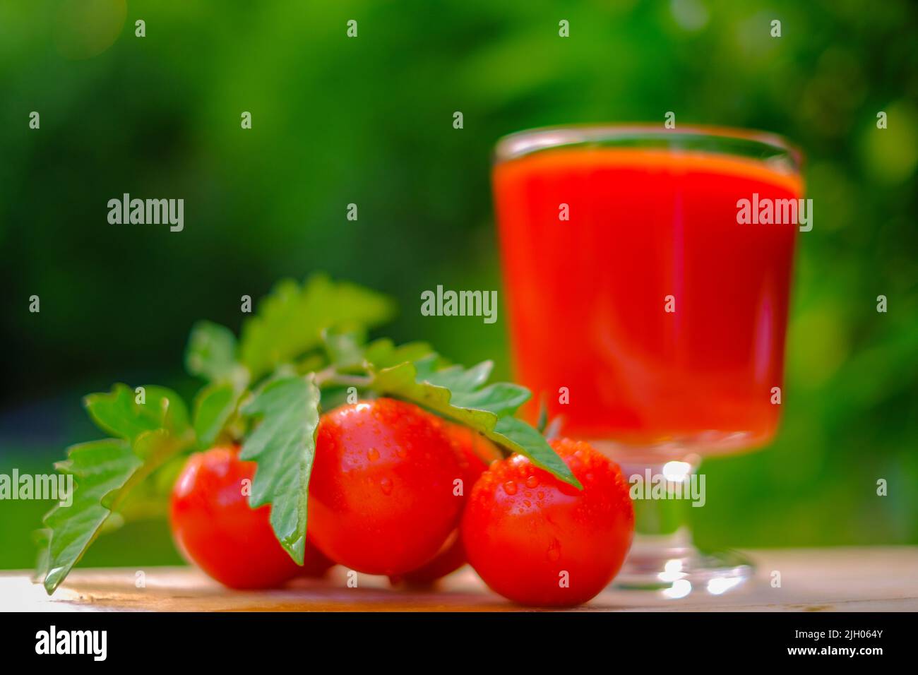 Tomato juice in a goblet and ripe tomatoes .Vegetable natural juices ...