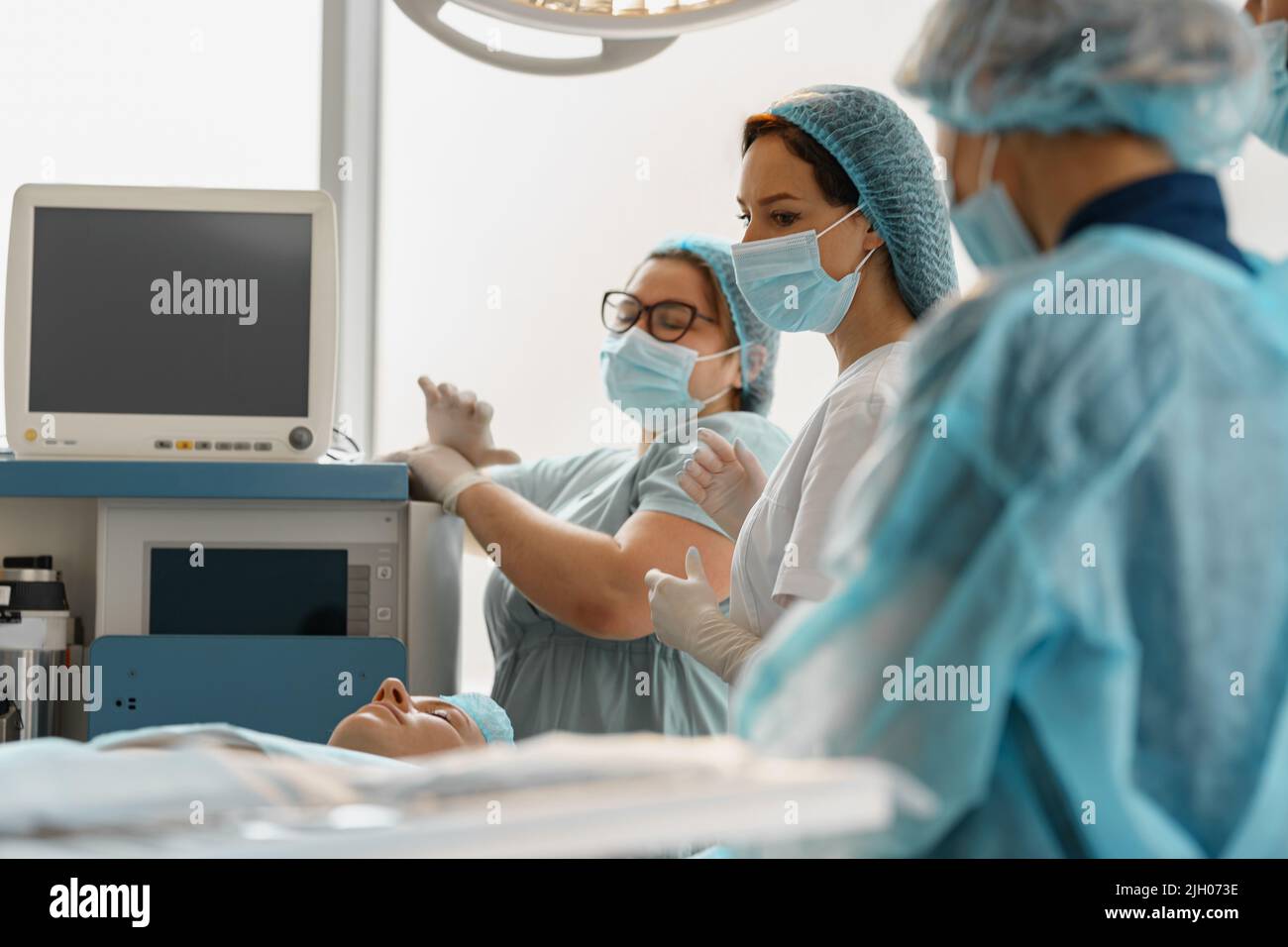 Concentrated professional surgical team working with a patient in an ...