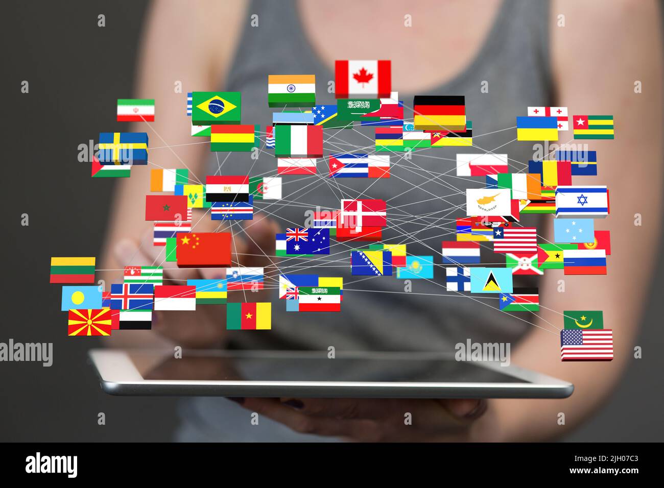 A 3D rendering of the world's national flags on a blurry background ...