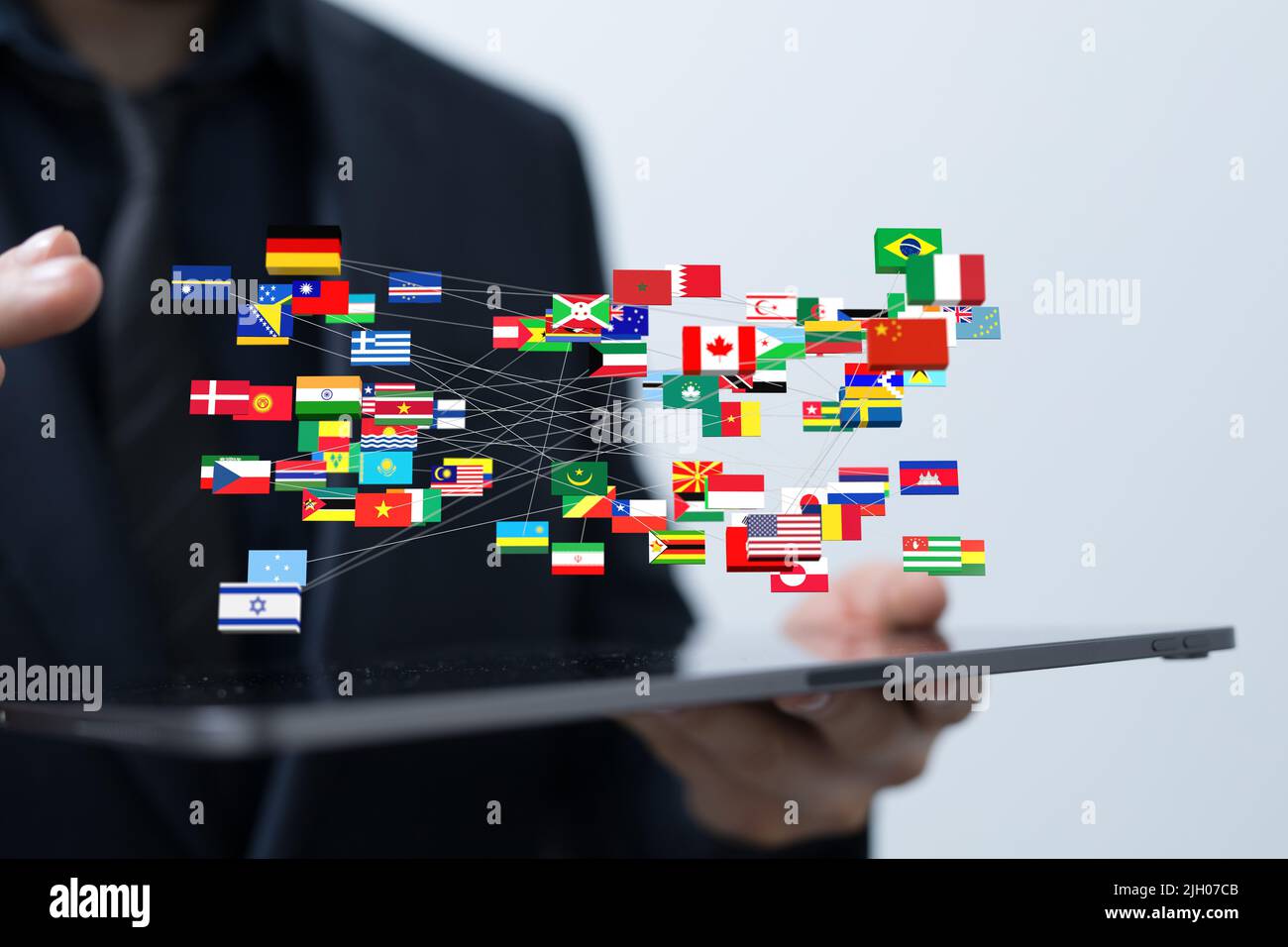 A 3D rendering of the world's national flags on a blurry background ...