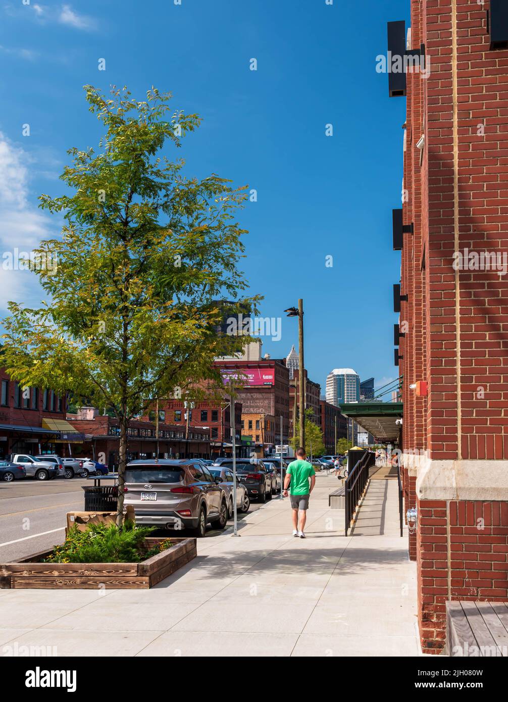 A man walking on the sidewalk along Smallman Street in the Strip ...