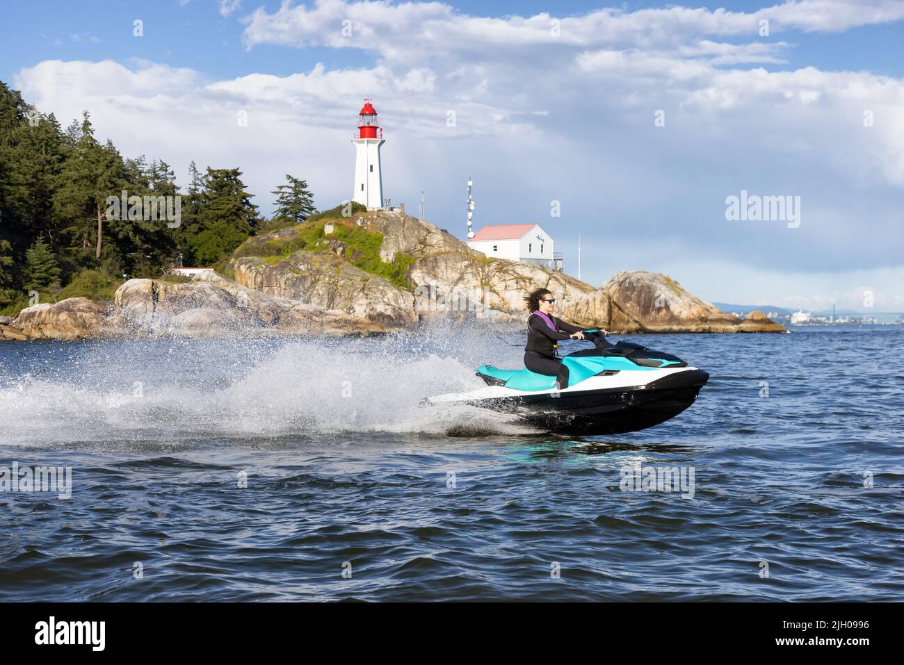 Adventurous Caucasian Woman on Sea-Doo riding in the Ocean Stock Photo ...