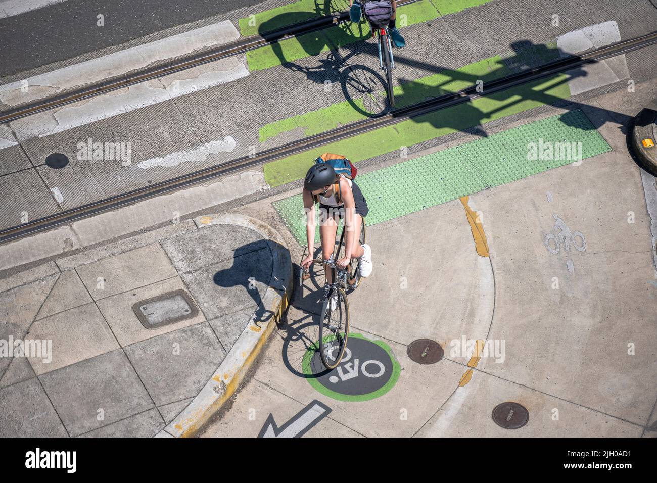 Group of amateur cyclists ride bicycles along the city sidewalk ...