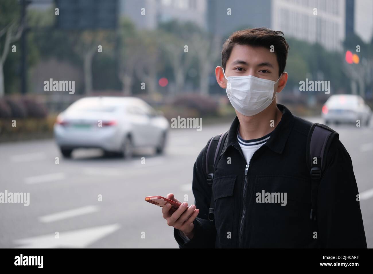 Asian man looking smartphone hi-res stock photography and images - Alamy