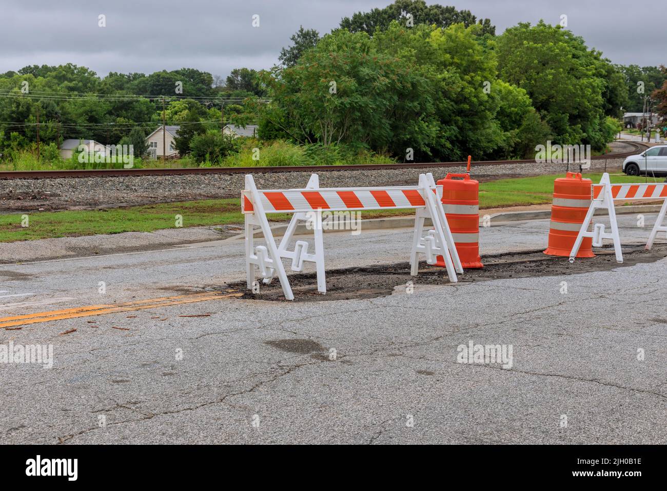 Damaged asphalt bad road with potholes repair with carriageway to ...