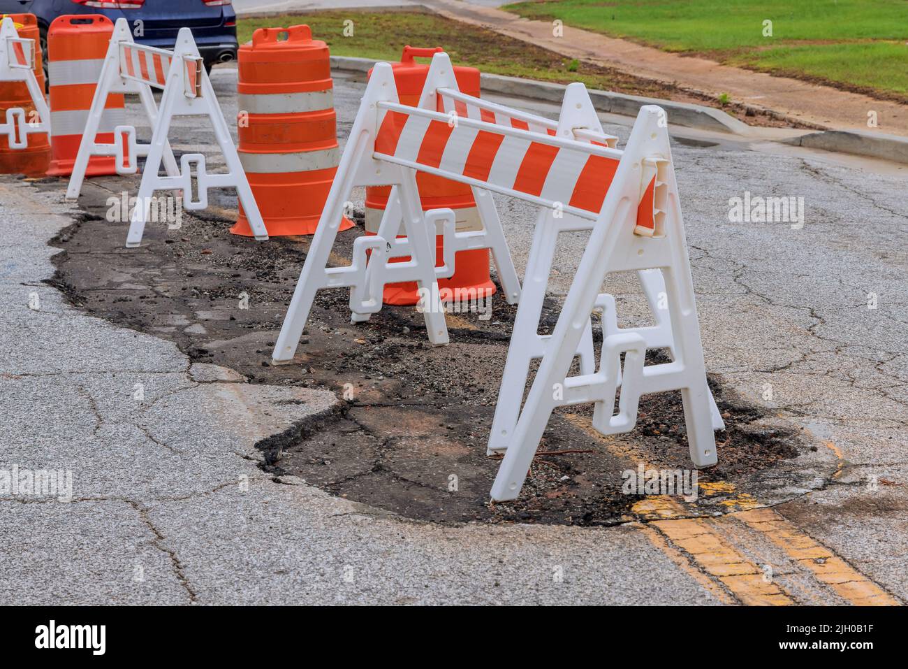 Road potholes damaged in the pavement need to be repaired with a ...